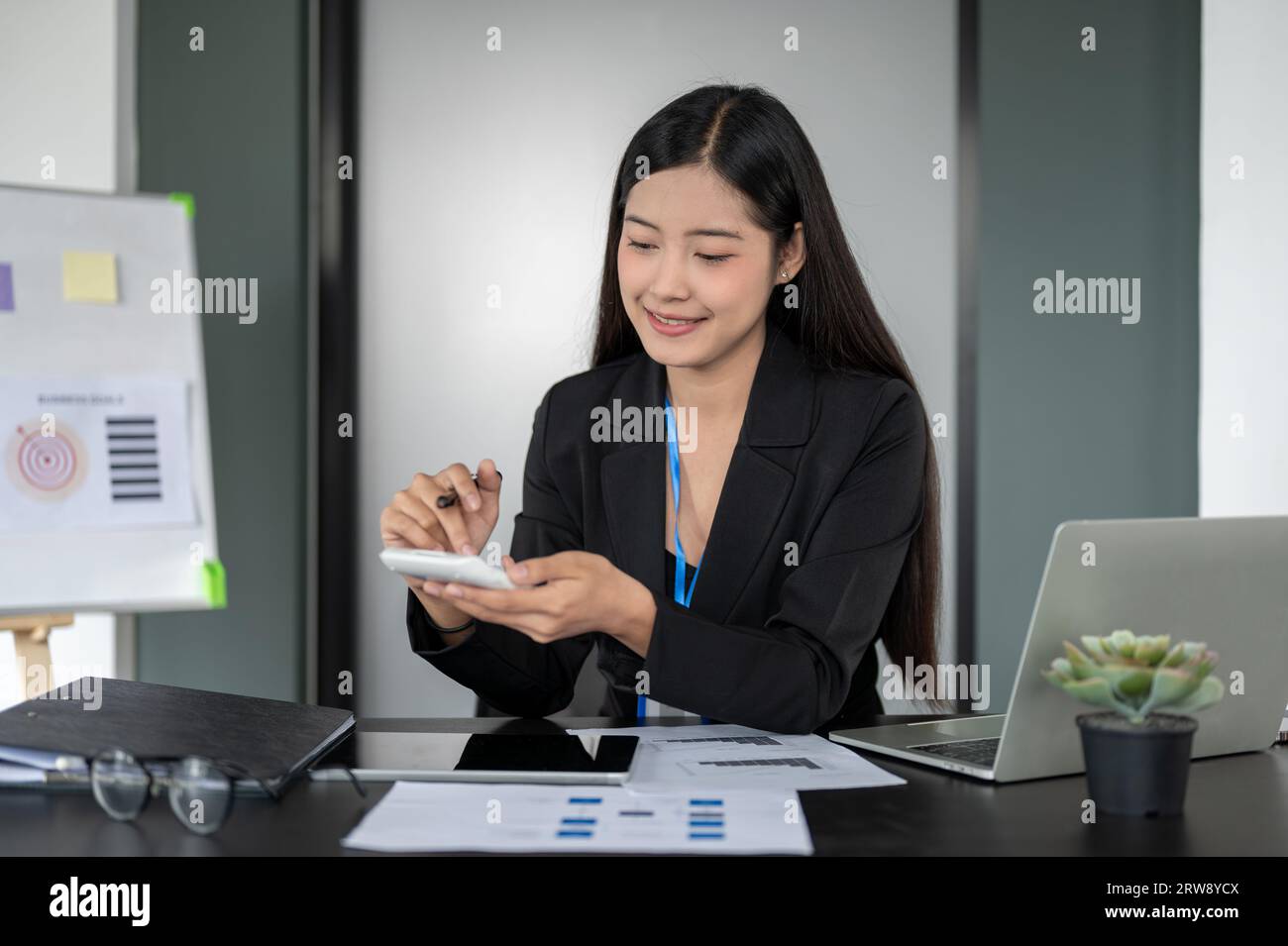 A beautiful and professional Asian businesswoman or female accountant ...