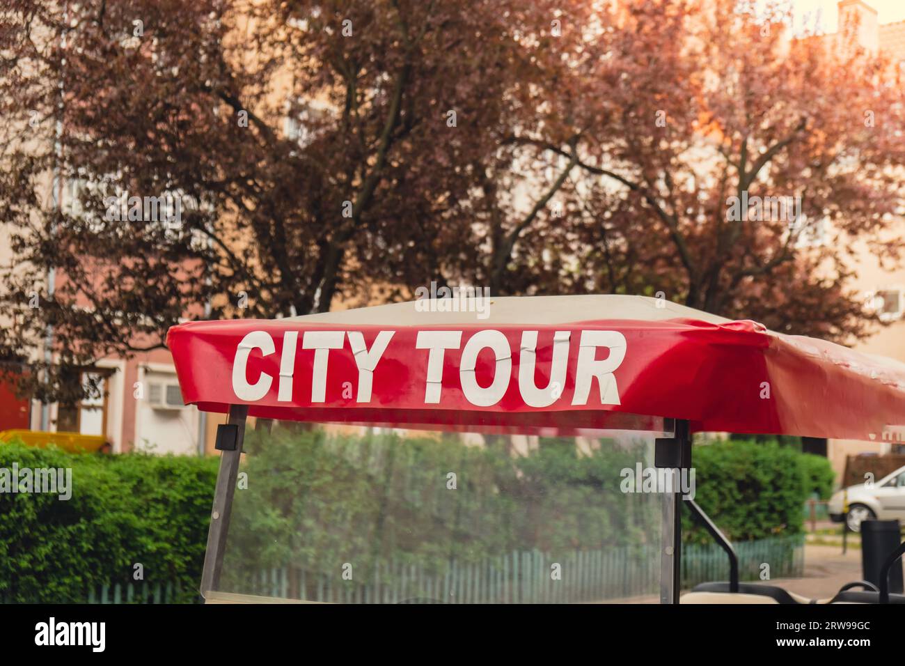 Red City tour car in the old city with text sign of Sightseeing city ...