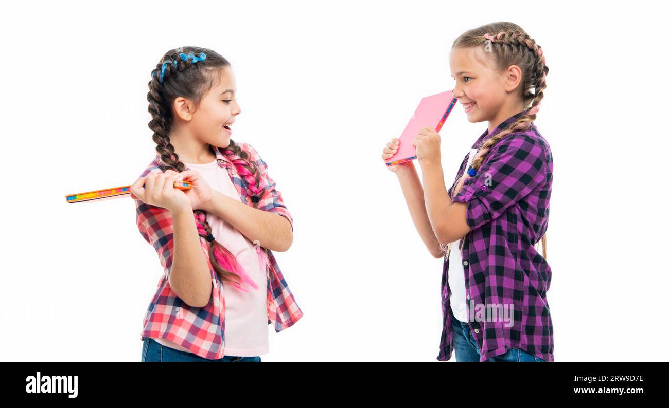 two girls children fighting with book homework at school Stock Photo ...