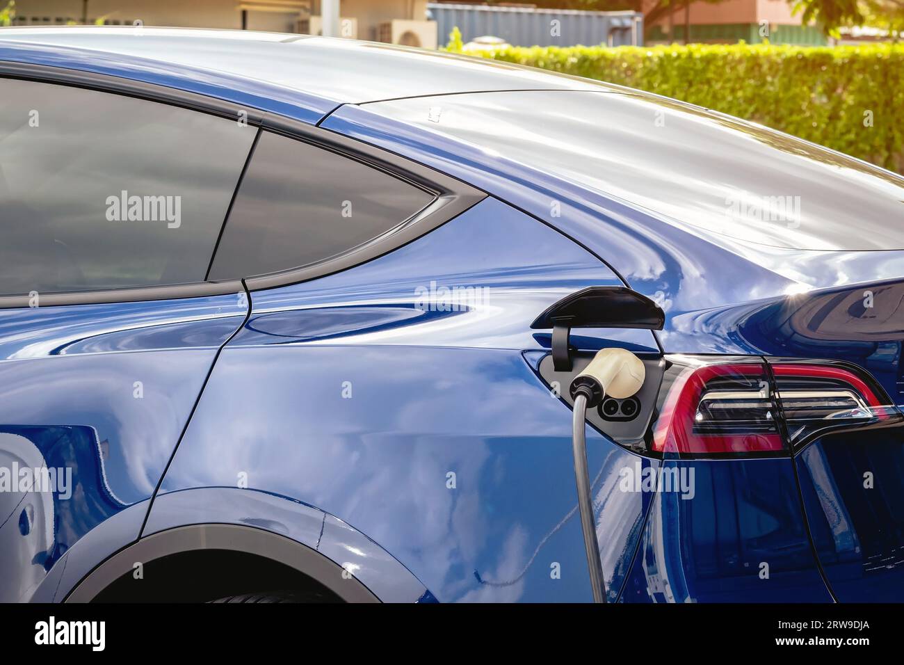 Charging electric vehicle with cable EV plugging in cable while ...