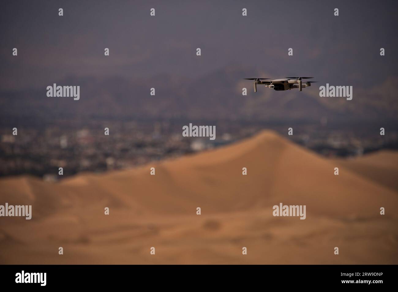 Drone flying above sand dunes of Huacachina desert in Peru Stock Photo ...