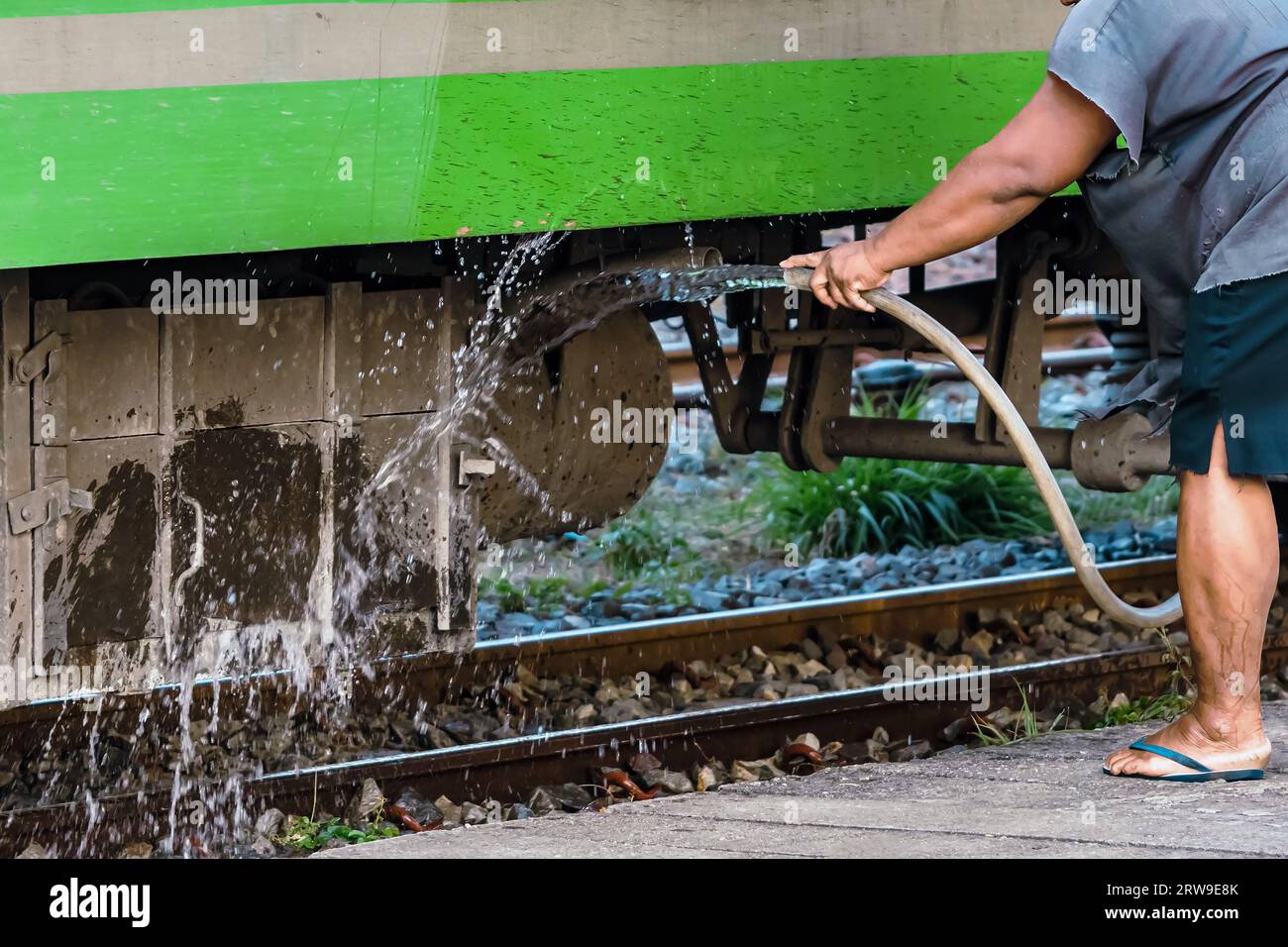 Male janitor clean and wash exterior of train. Worker cleaning the ...