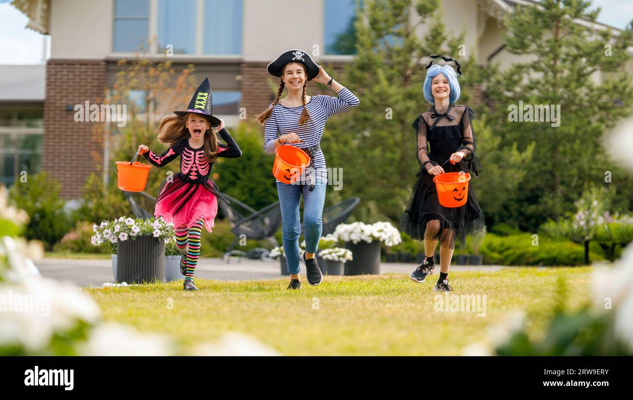 Happy kids at Halloween party. Children are wearing carnival costumes ...