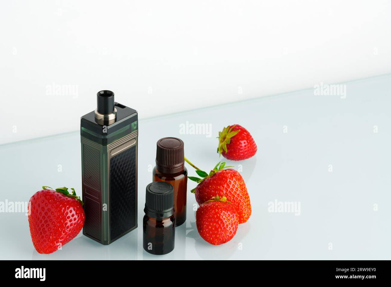Electronic cigarette liquid with strawberry flavor on white background ...