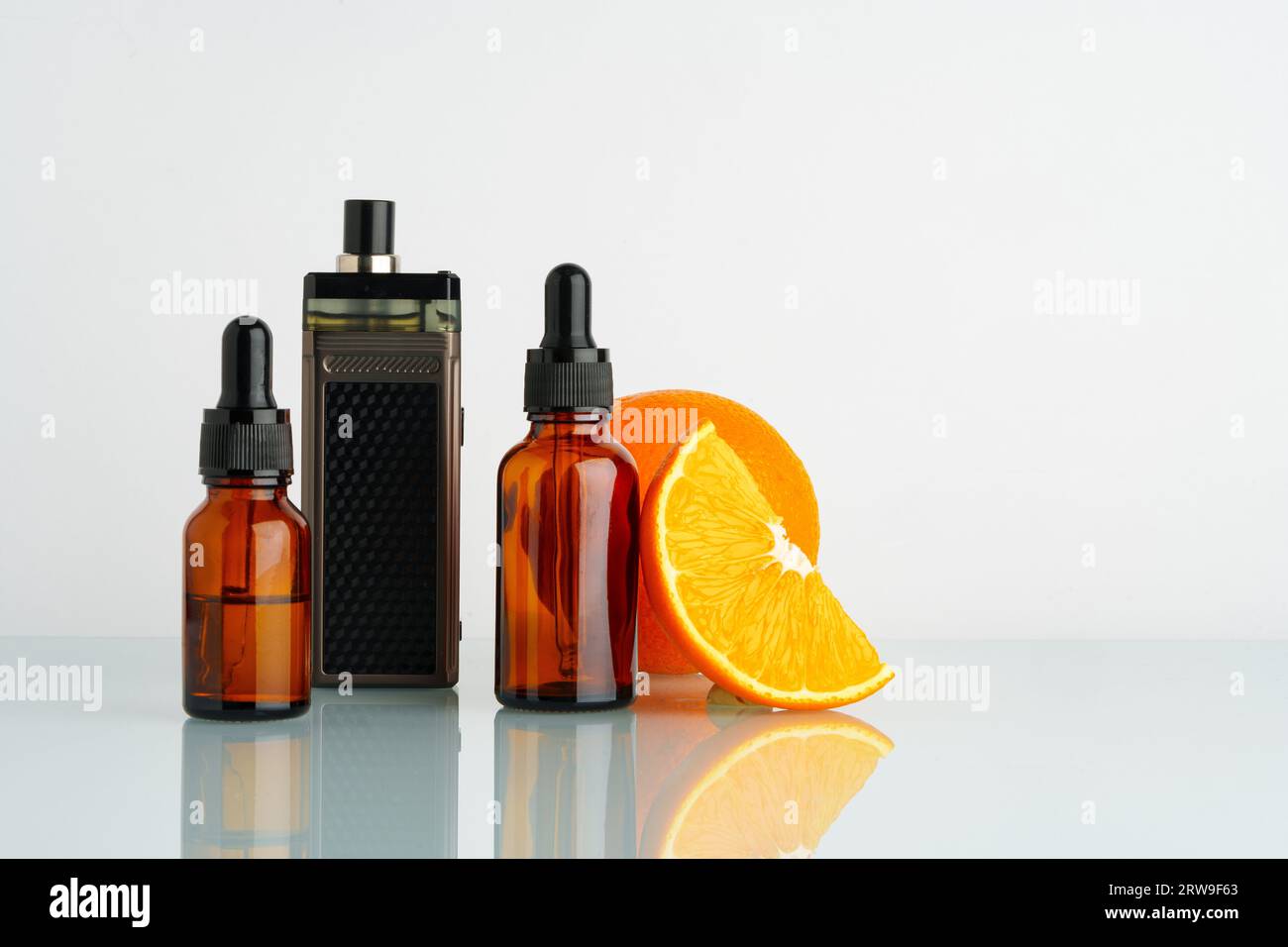 Vape liquid with orange flavor on white background Stock Photo - Alamy