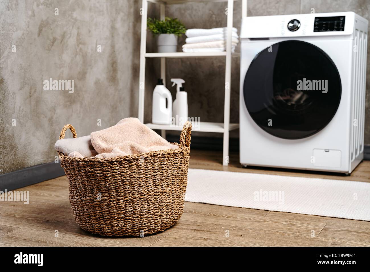 Washing machine in a gray modern laundry room Stock Photo - Alamy
