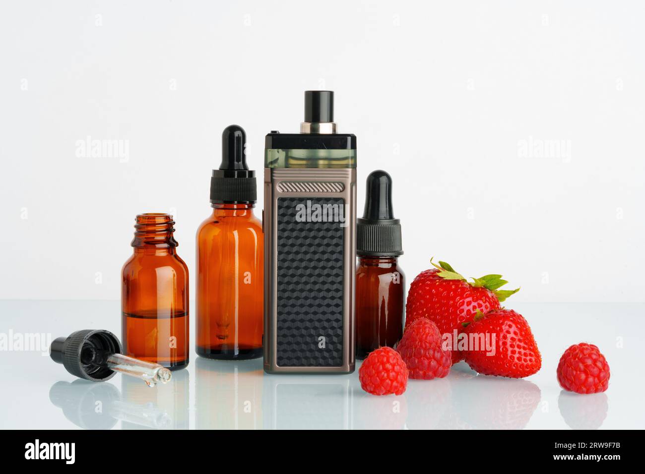 Electronic cigarette liquid with strawberry flavor on white background ...