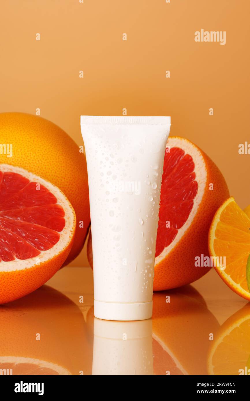 Cosmetic container on background of cut citrus fruit Stock Photo - Alamy