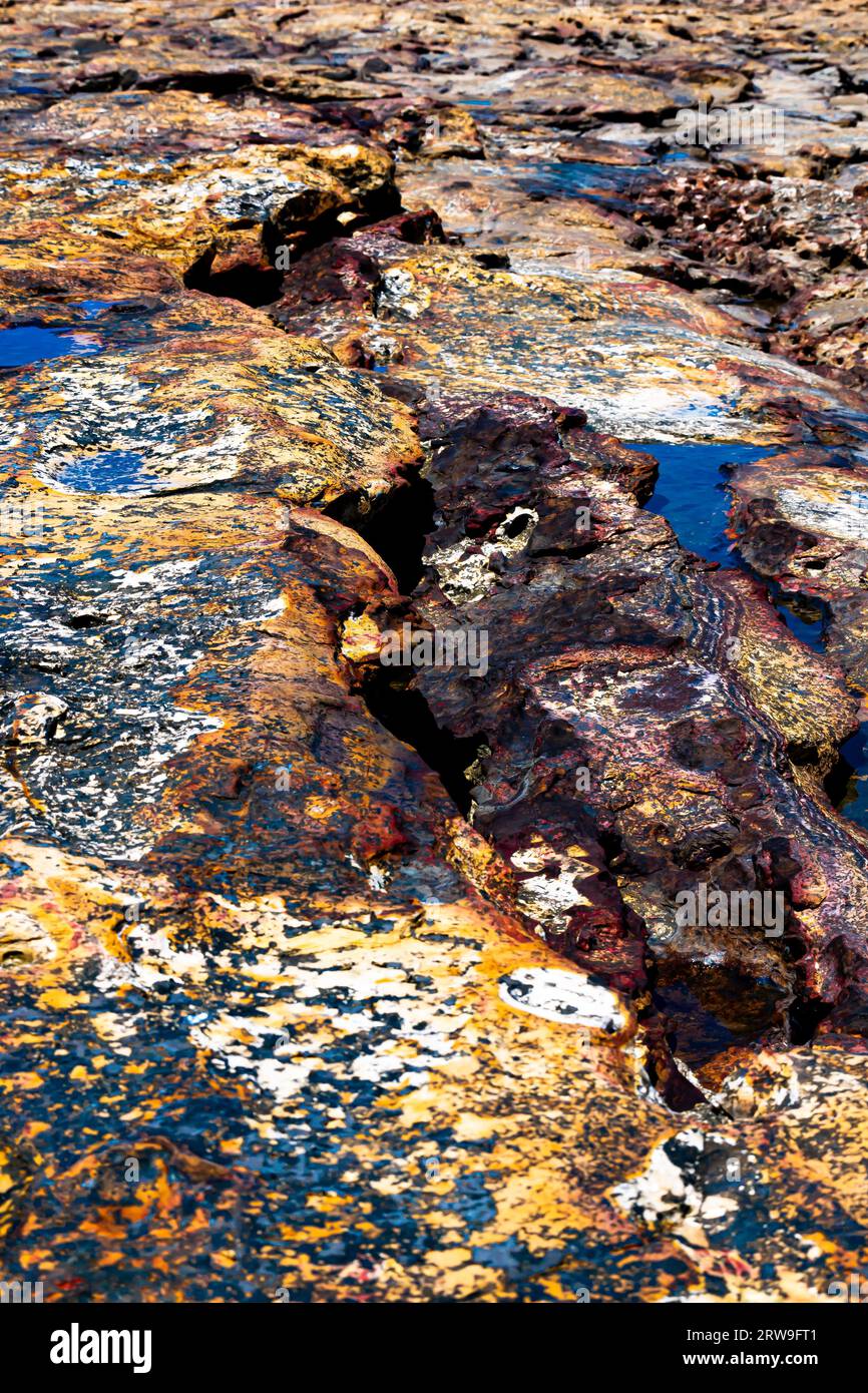 Multi-colored beach rocks of Darwin in North Australia at low tide ...