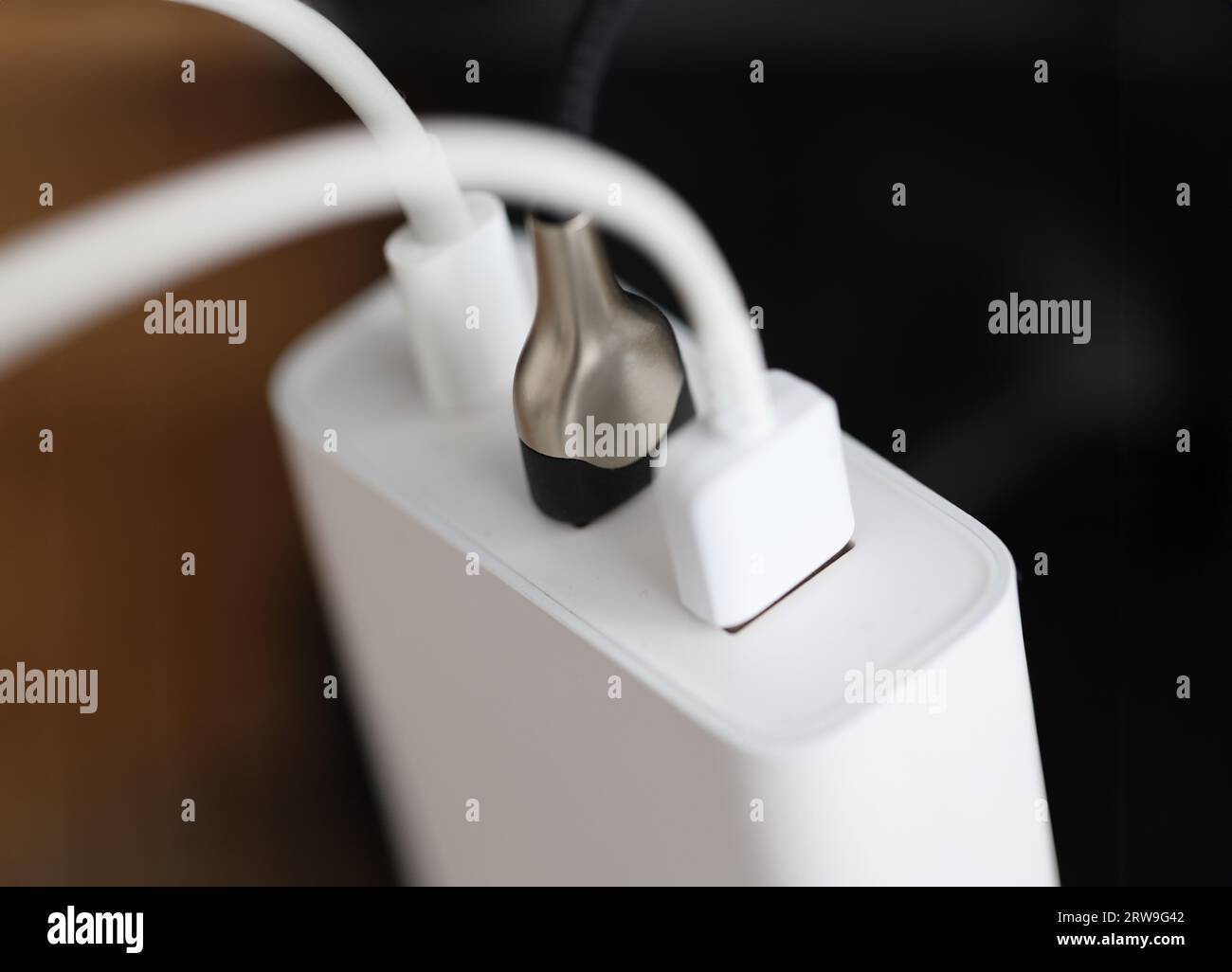 White usb cable is plugging into socket closeup Stock Photo - Alamy