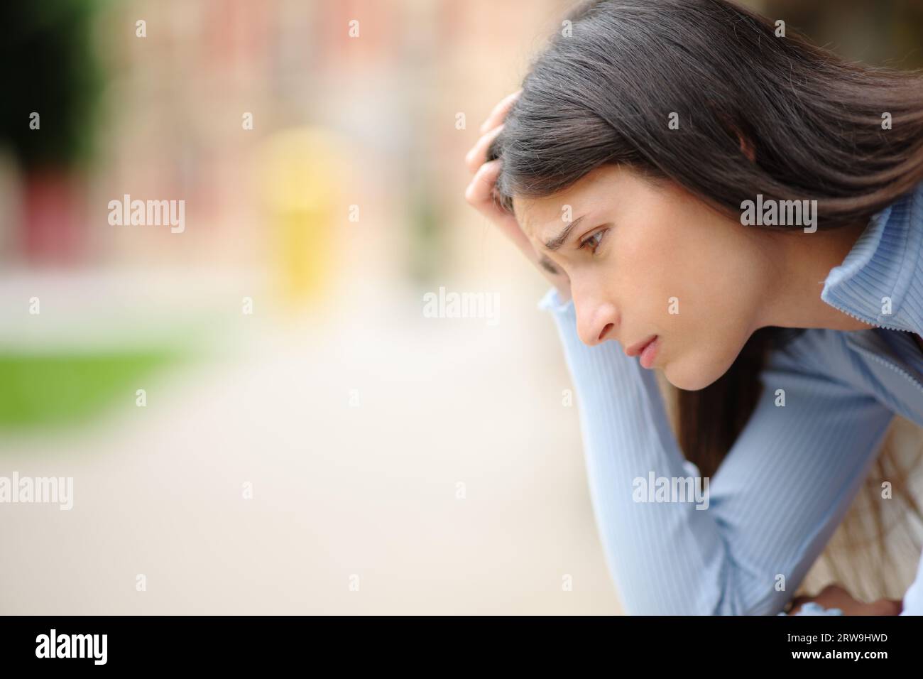 Profile portrait of a worried woman complaining in the street Stock ...