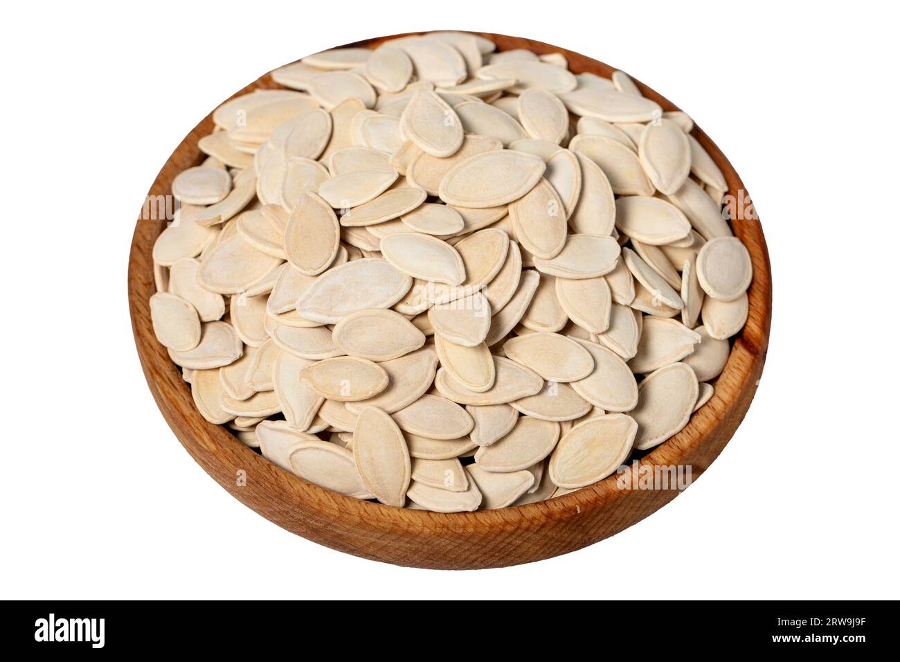Pumpkin seeds in wooden bowl. Shelled pumpkin seeds isolated on white ...