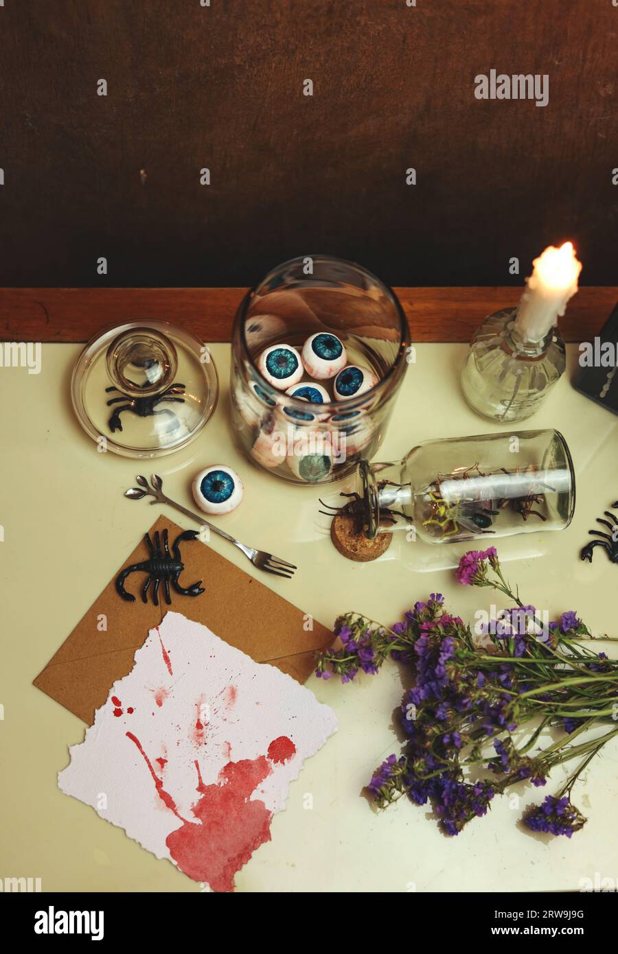 halloween still life with a blank bloody card, eyeballs, scorpions ...