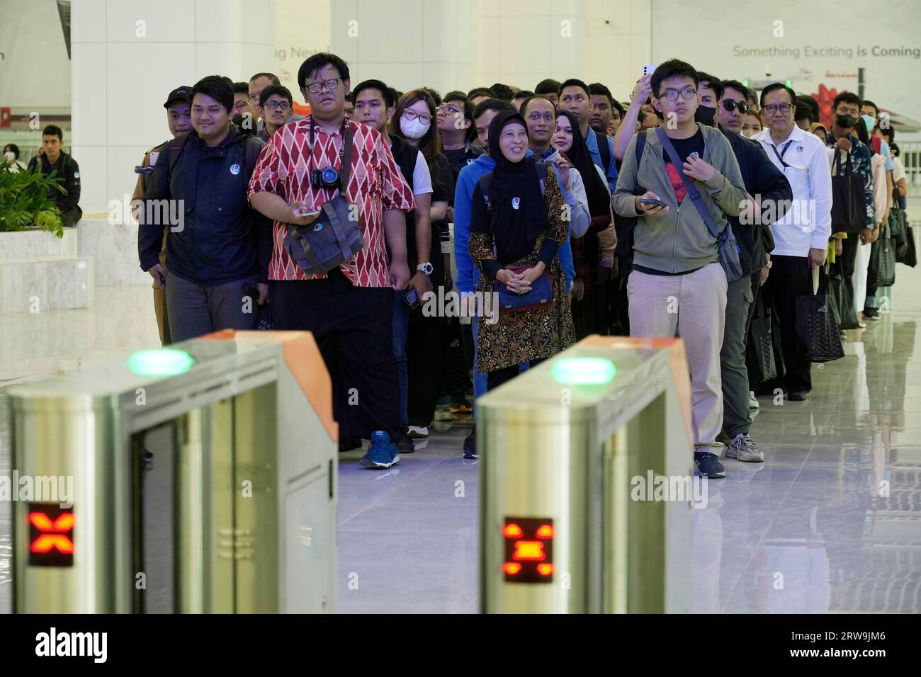 People line up for a test ride of high-speed railway at Halim station ...