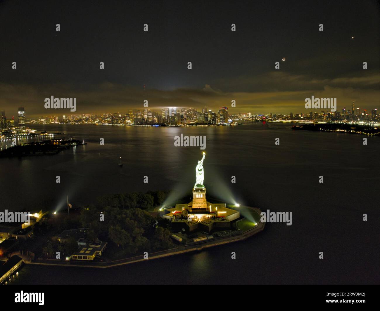 A nighttime view of the New York City skyline, featuring a tall tower ...