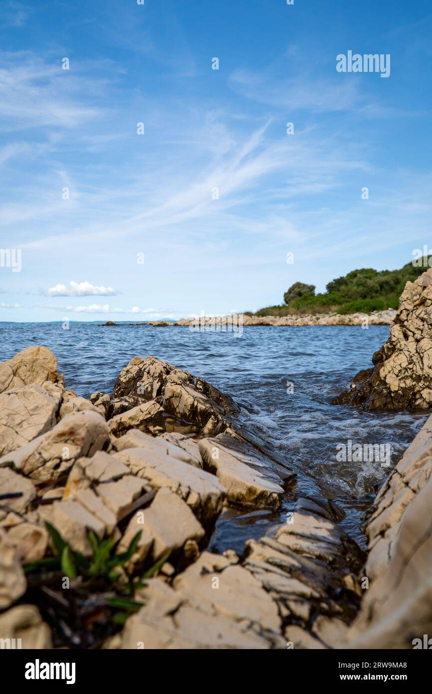 A vertical shot of a beautiful sunny rocky shoreline in Croatia Stock ...