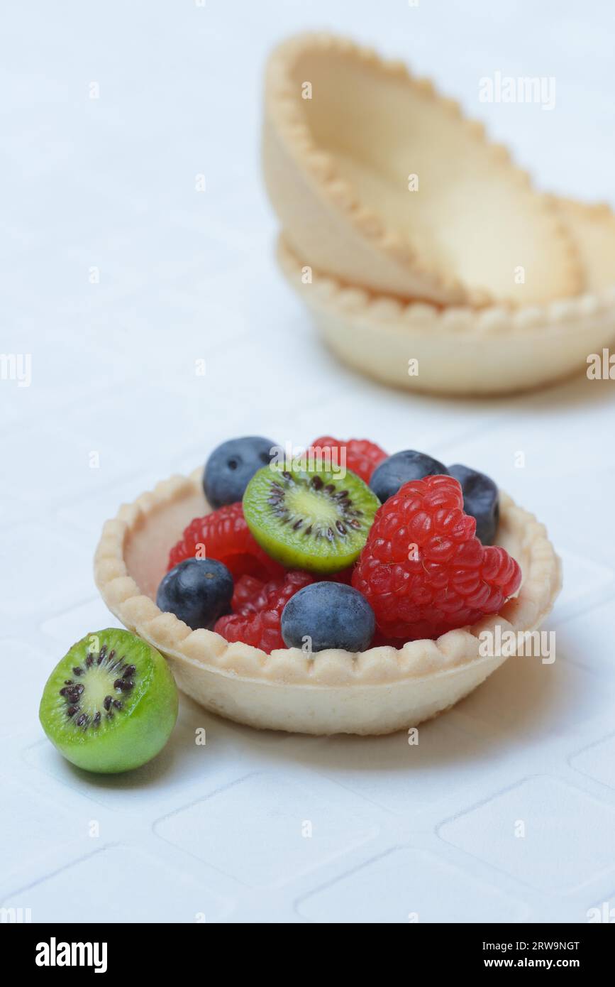 Fruit in tartlet base, raspberry, blueberry, mini kiwi Stock Photo - Alamy