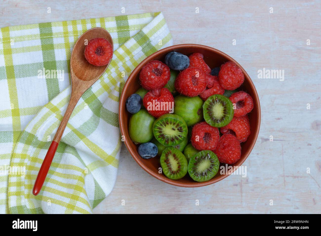 Fruits in shell, raspberries, blueberries, minikiwi Stock Photo - Alamy