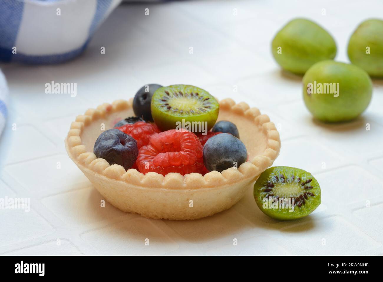Fruit in tartlet base, raspberry, blueberry, mini kiwi Stock Photo - Alamy