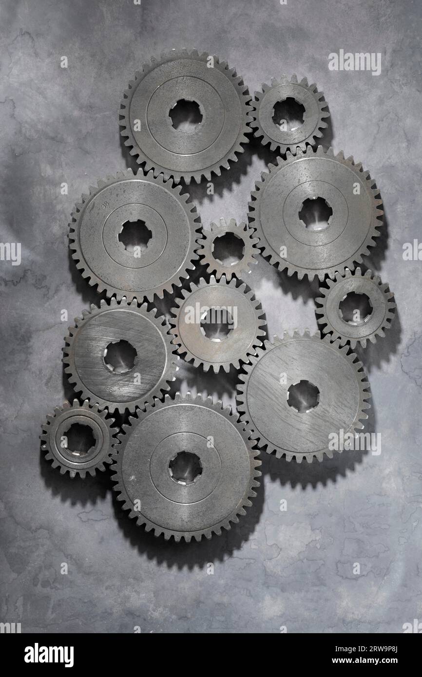 Old metallic cog gear wheels on grey background Stock Photo - Alamy