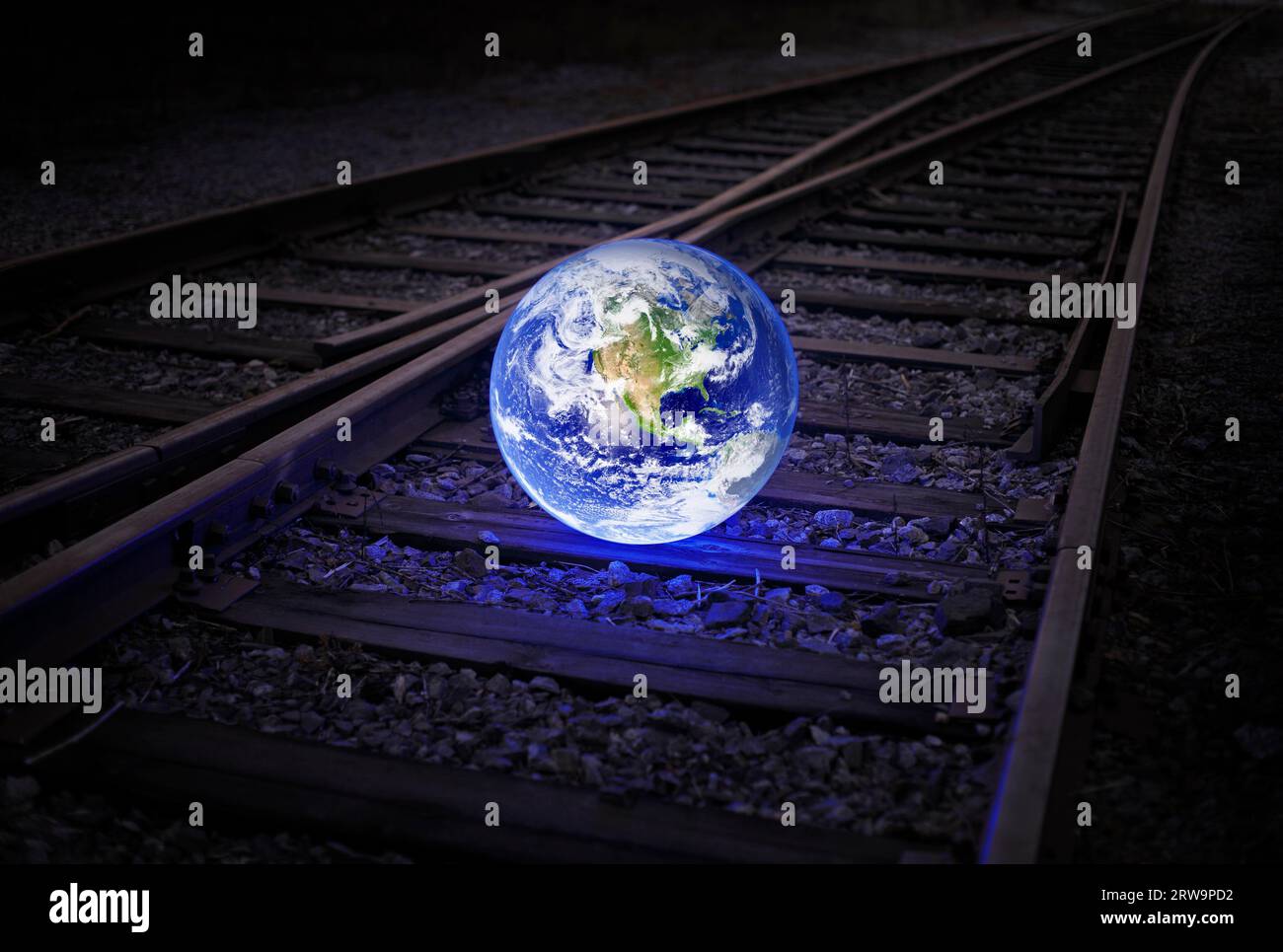 Glowing earth on an old railroad track. Earth image provided by NASA ...
