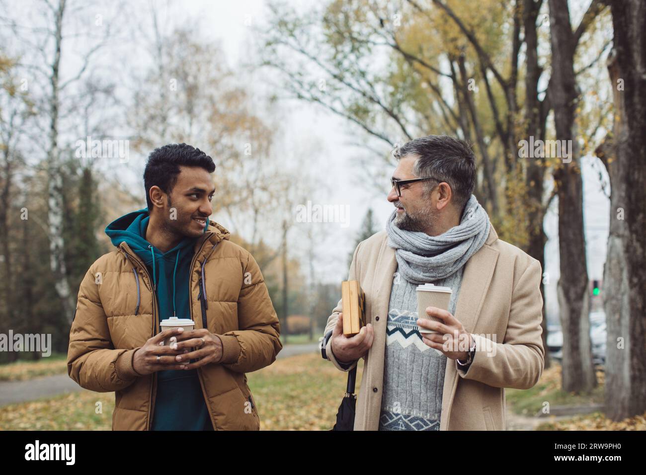 Two young people in a park talking hi-res stock photography and images ...
