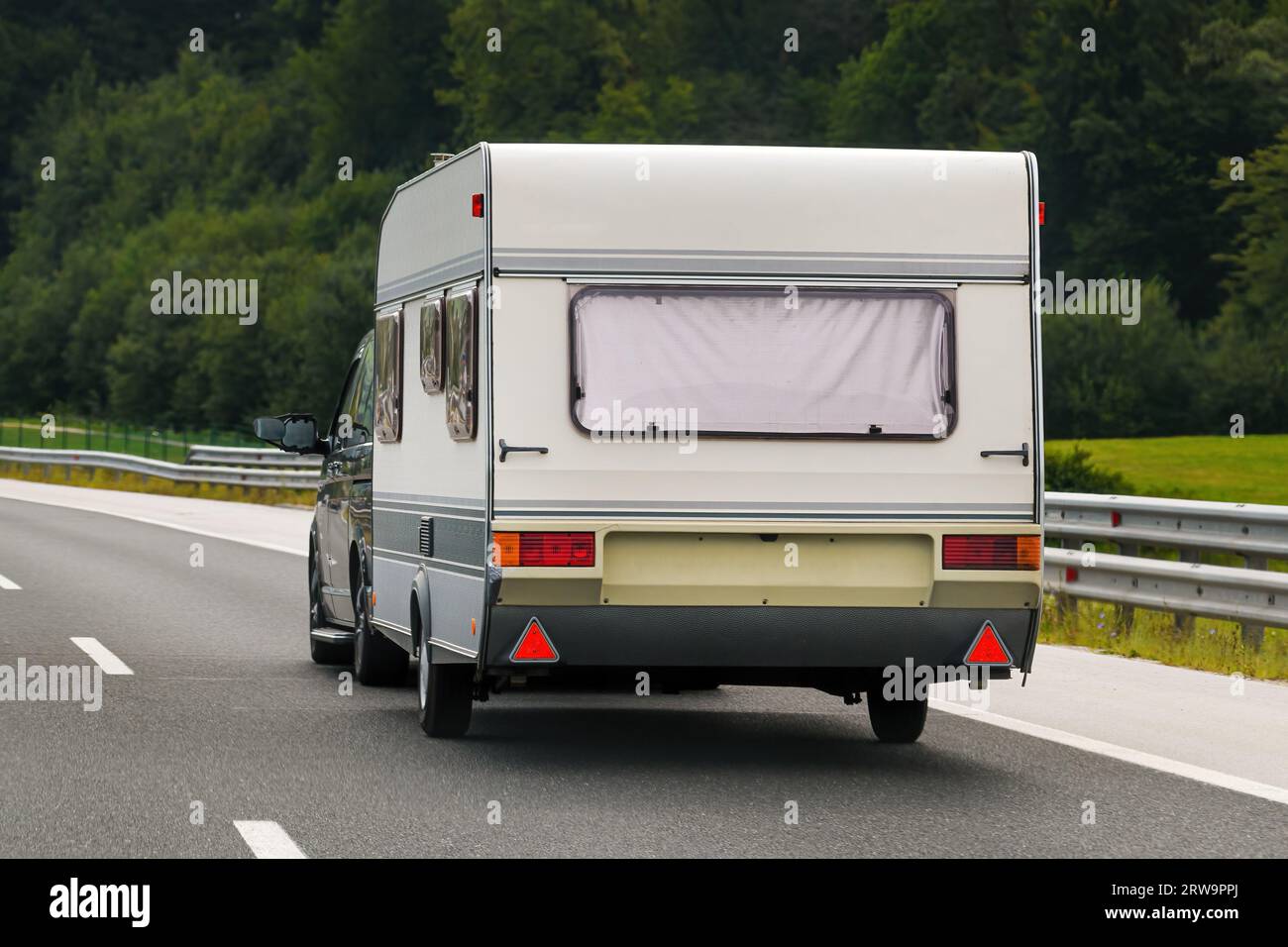 Camper van with trailer on highway, selective focus Stock Photo - Alamy