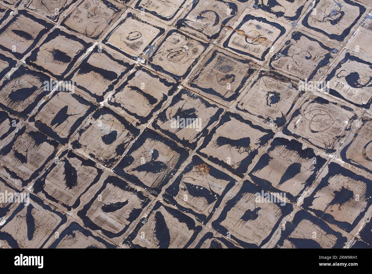 Bitumen residues on a house wall, taken diagonally and filling the ...