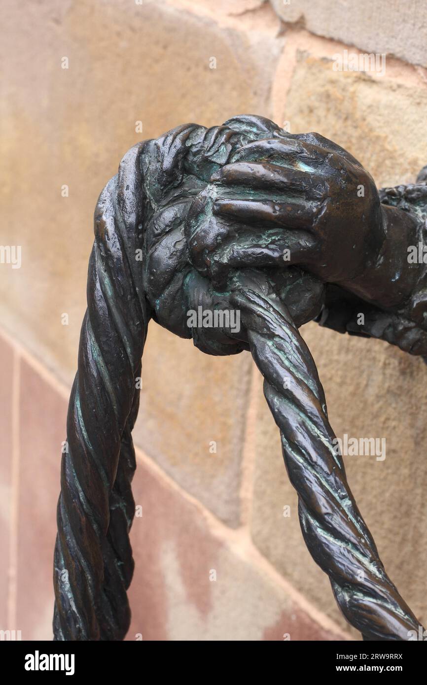 Sculpture of hands holding a rope Stock Photo - Alamy