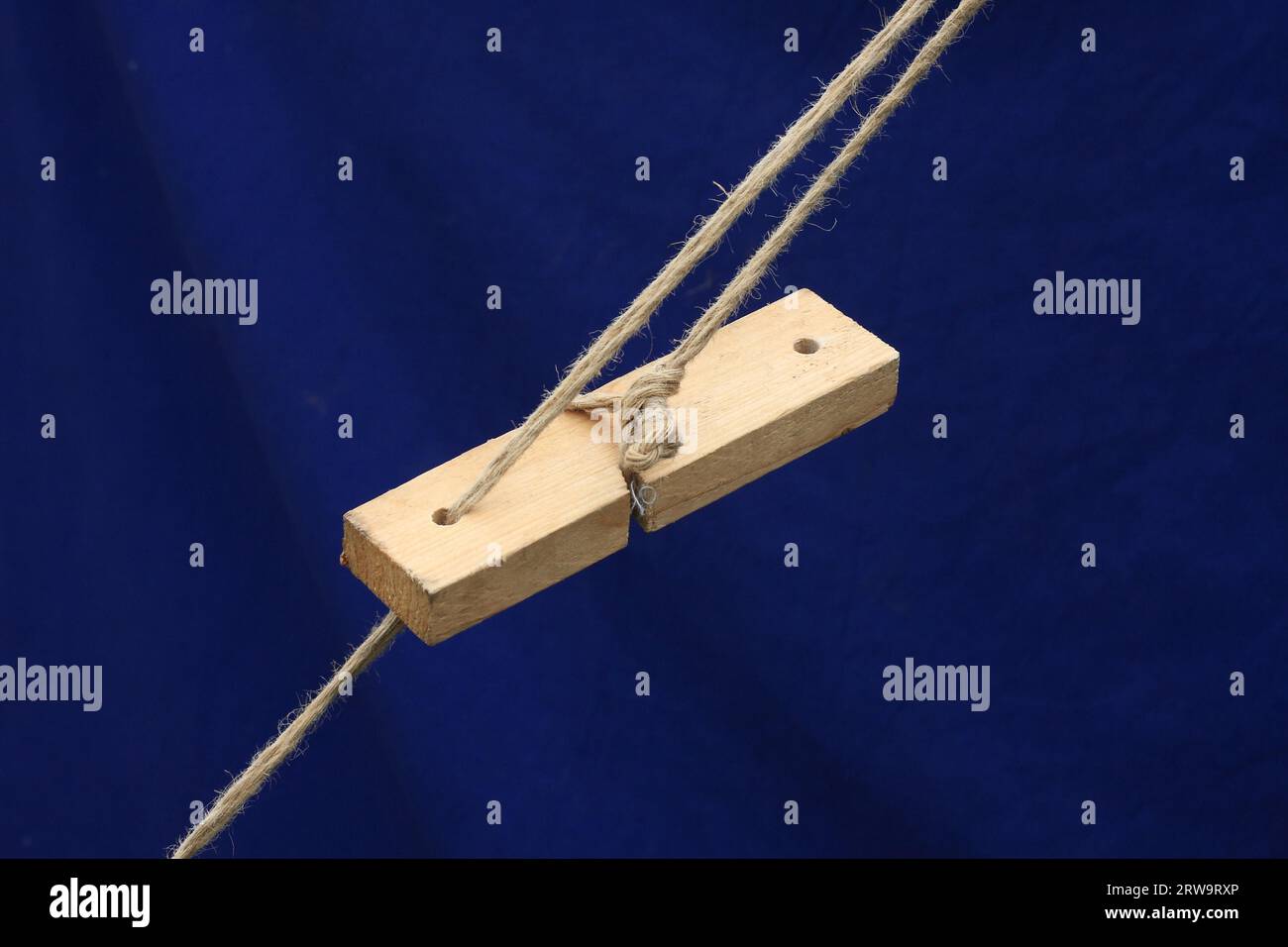 Rope tensioner made of wood, background blue tent Stock Photo - Alamy