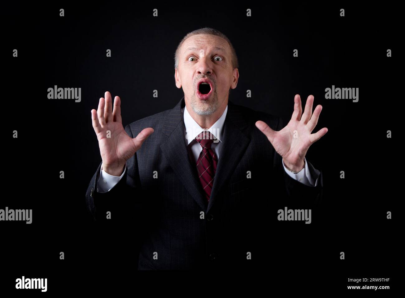 Scared mature man stretching arms and shouting at camera Stock Photo ...