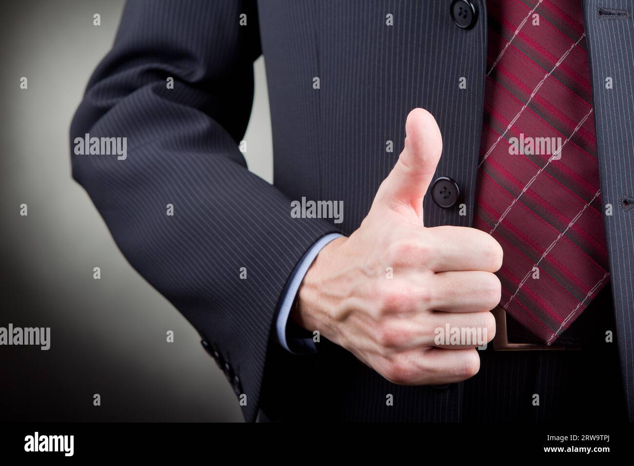 Approval thumbs up gesture. Neutral background Stock Photo - Alamy