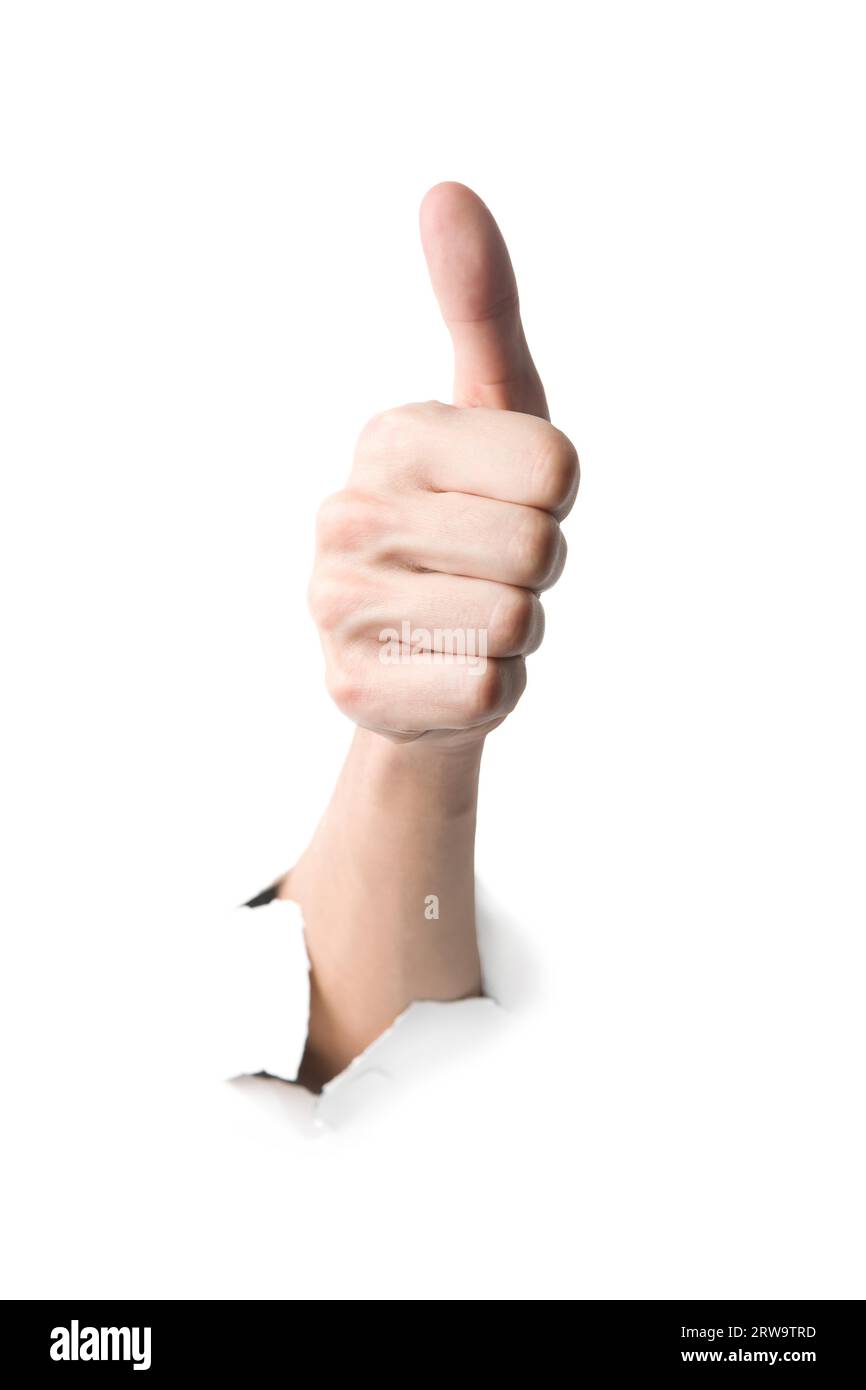 Thumbs up gesture showing through the paper Stock Photo - Alamy