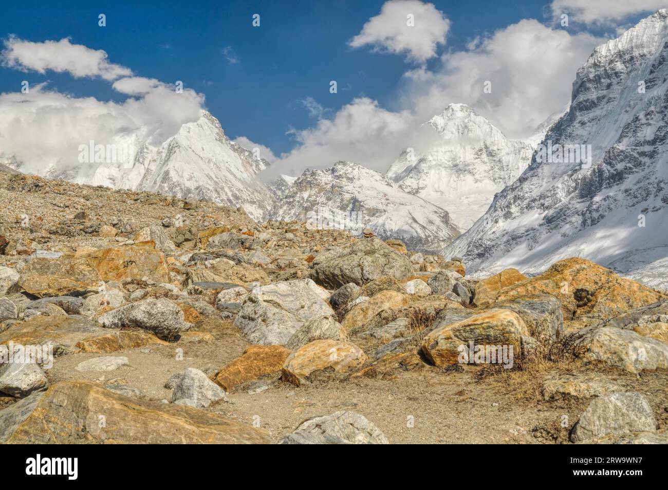 Panoramic view of snowy mountains sloping down into a rocky valley ...