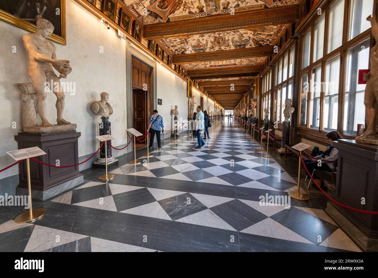 A long corridor of some of the 28 statues and busts of Roman art along ...
