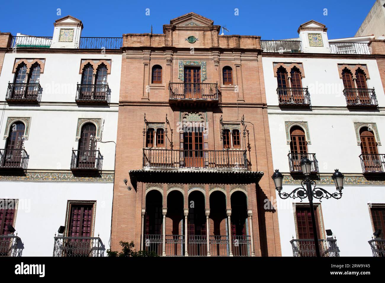 Traditional Andalusian apartment houses with arched windows in El ...