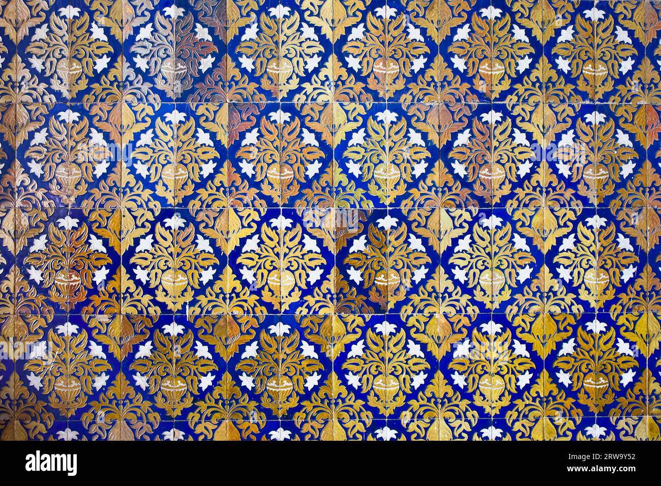 Floral design on an old tiled wall of Plaza de Espana corridor, Spain ...