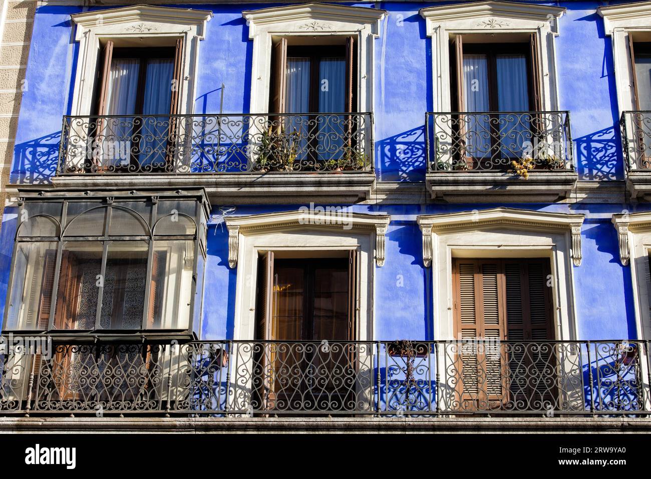 Historic apartment building with balconies blue painted facade in ...