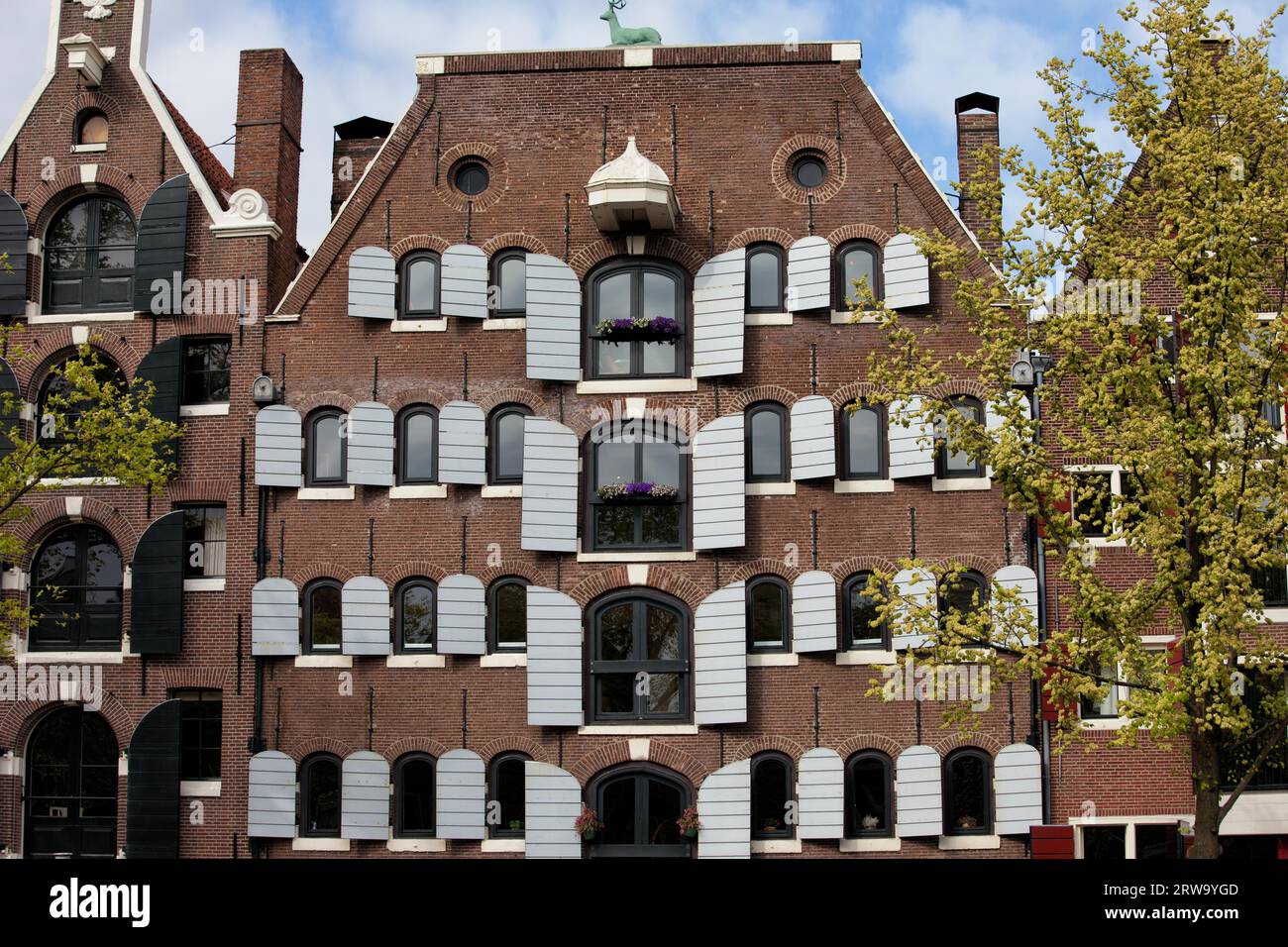 Apartment building with white window shutters in the city of Amsterdam ...