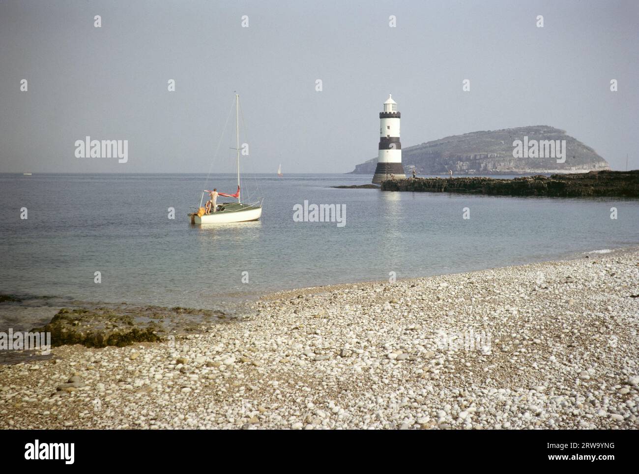Yacht and lighthouse view to Priestholm, Puffin Island, Ynys Seiriol ...