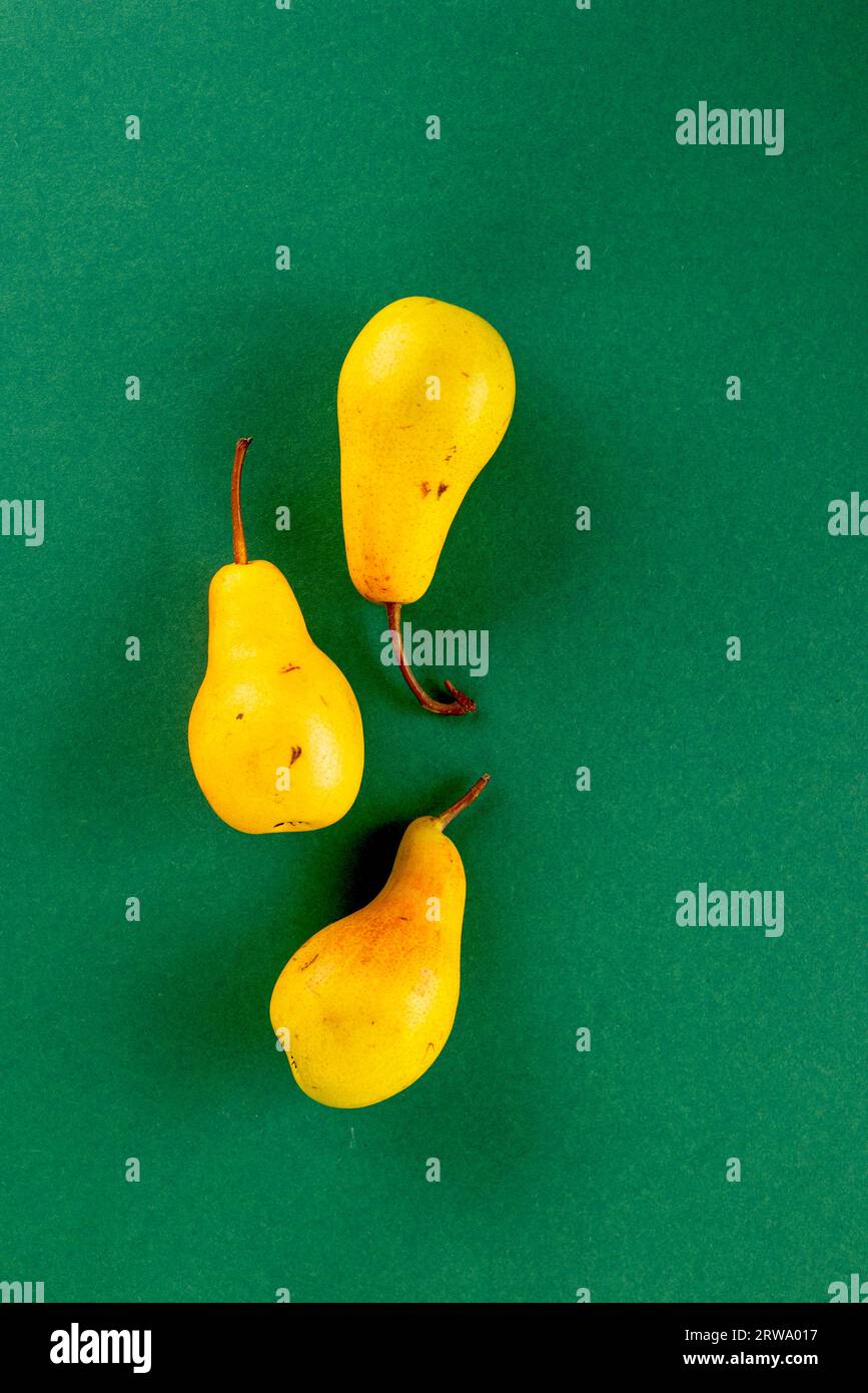 fresh pear closeup. Green background with yellow-green pears Stock ...