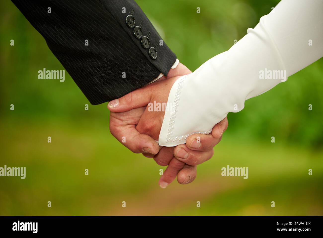Wedding couple hand in hand Stock Photo - Alamy