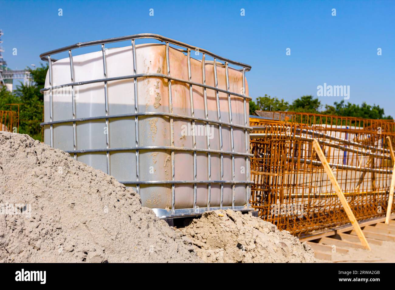 White square water tank, cubic, with metal grate, huge reservoir for ...