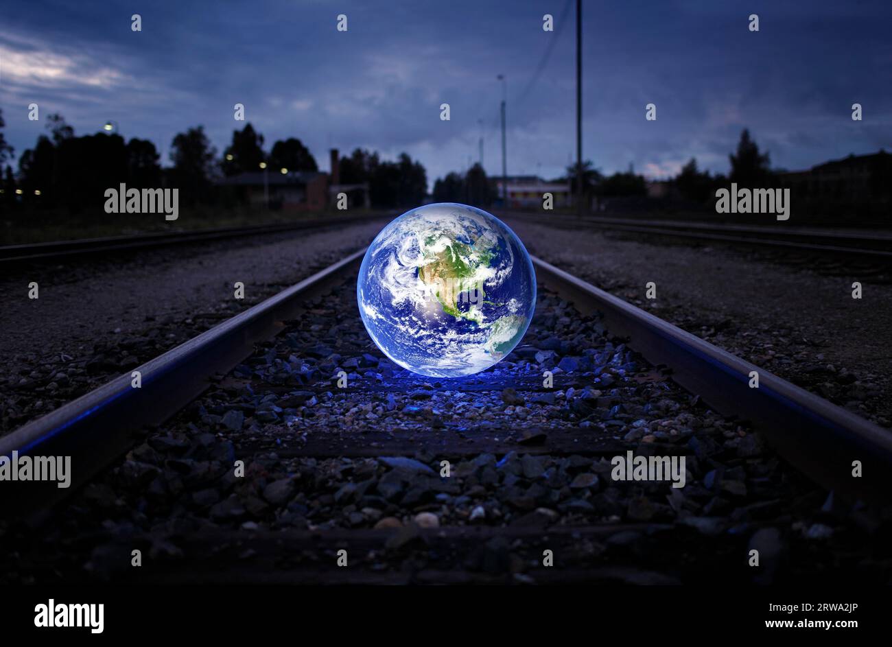 Glowing earth on an old railroad track. Earth image provided by NASA ...