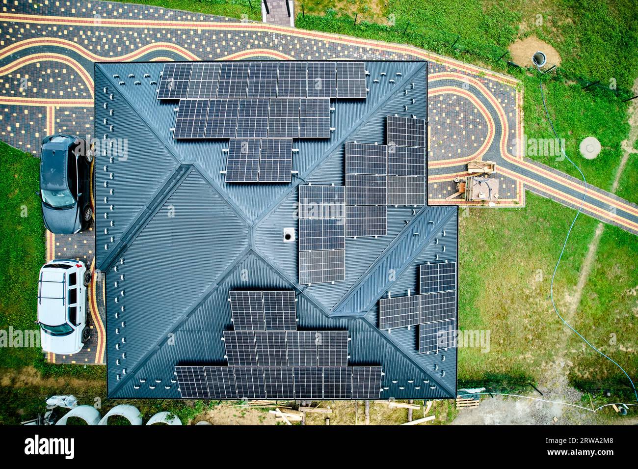 Aerial top view of solar panels on roof. Modern house with alternative ...