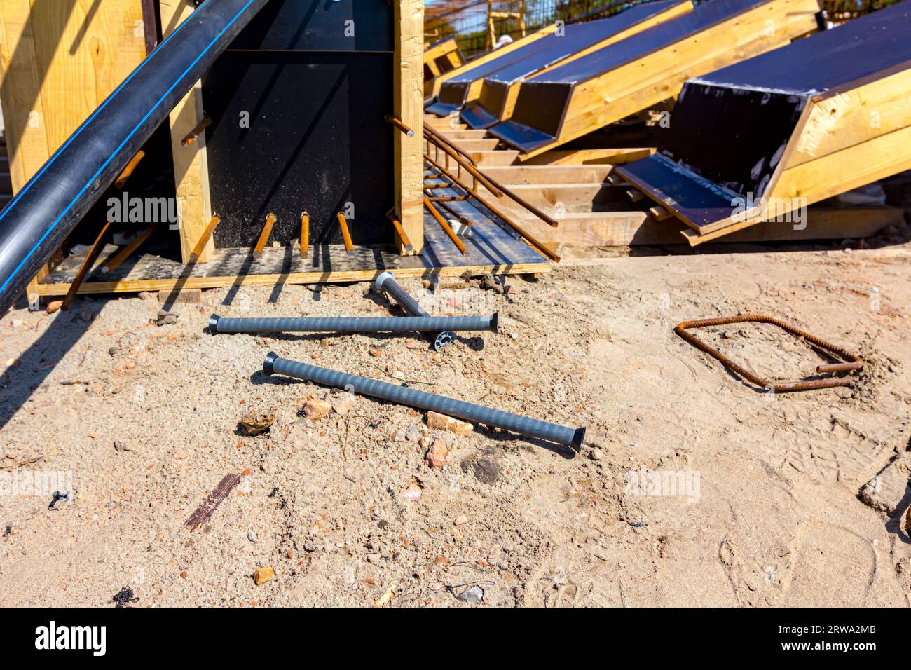 A few screws, holders for bridge molds placed on the ground, in ...
