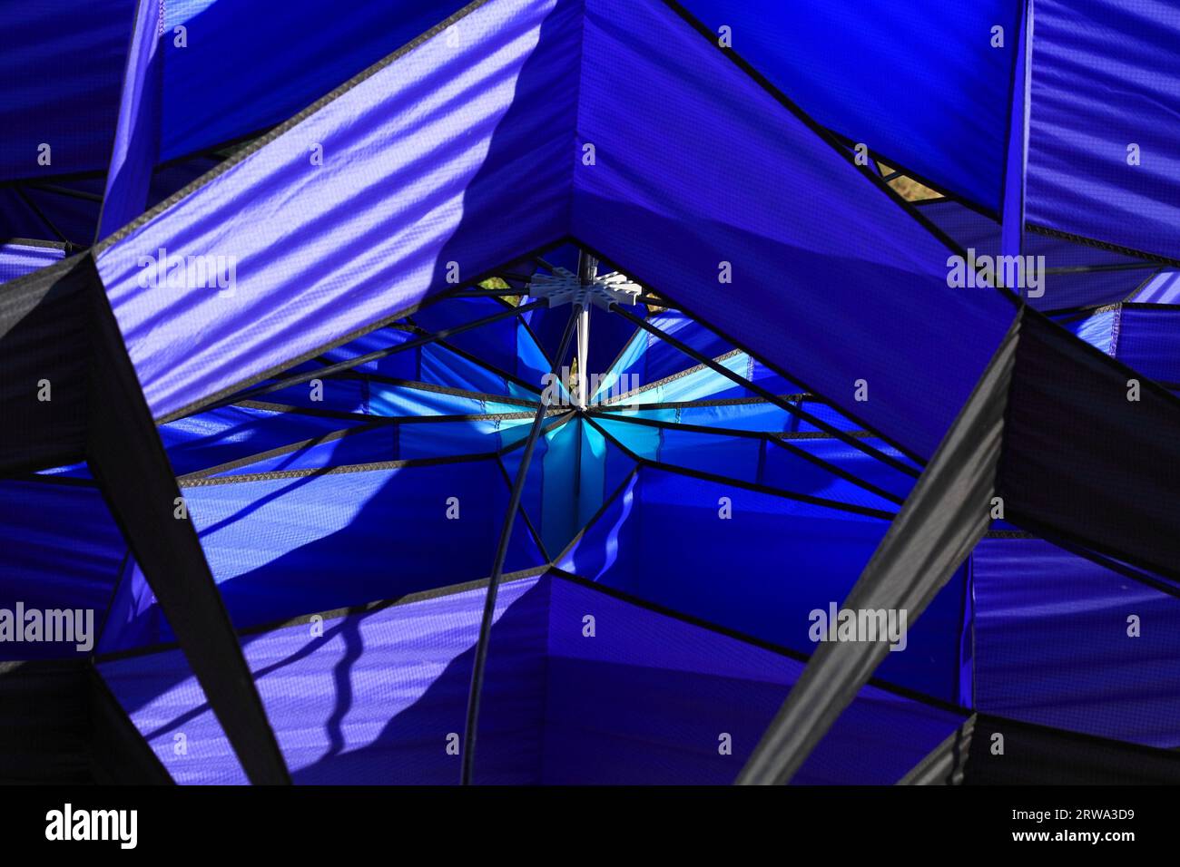 The interior of a blue-black stunt kite, shot full-frame in landscape ...