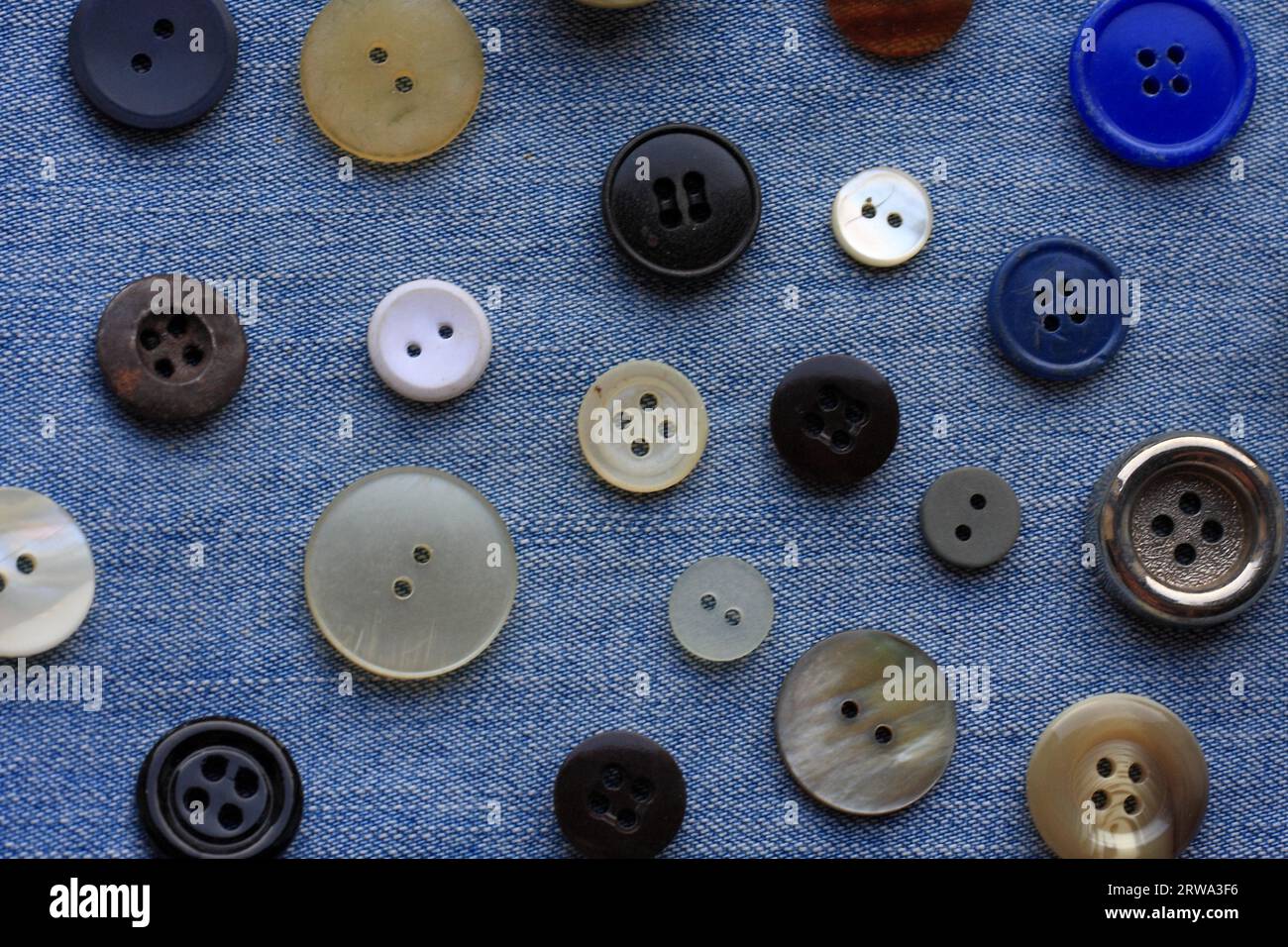 Buttons in different colours and sizes on denim, format-filling Stock ...