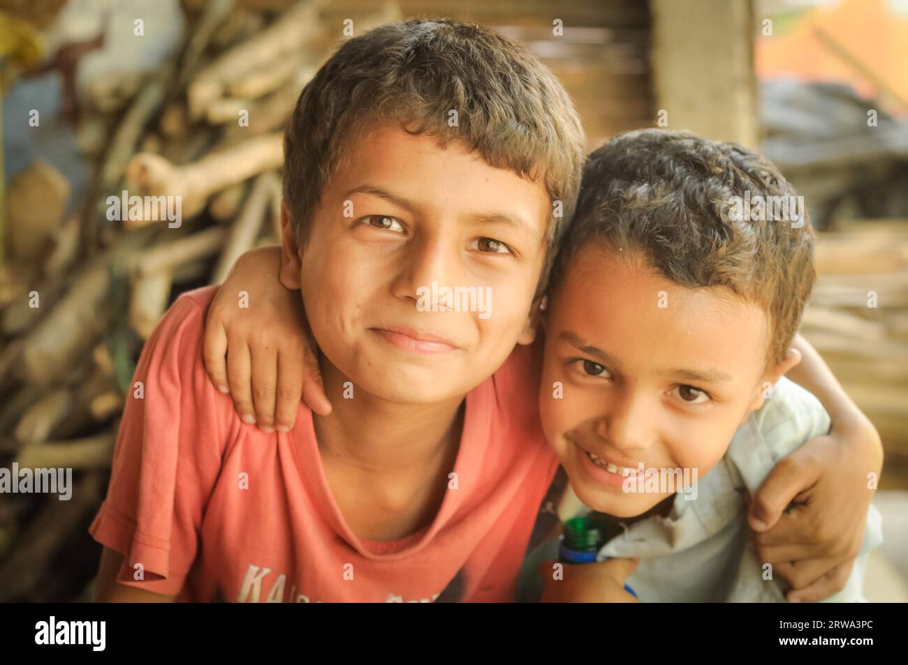 Damak, Nepal, circa May 2012: Two young brothers with brown eyes hug ...