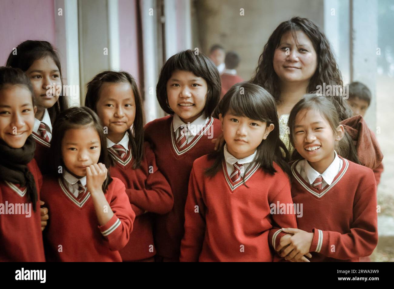 Lungdai, Mizoram, circa April 2012: Young girls dressed in red school ...